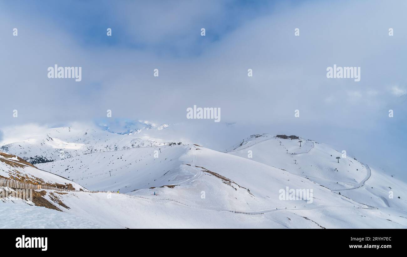 Long ski pistes and ski lifts winding through snow capped Pyrenees ...