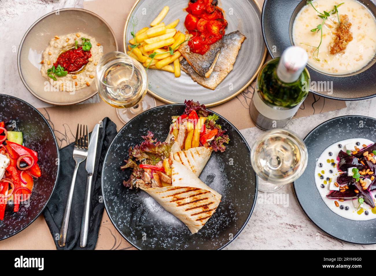 Set of Greek dishes, Mediterranean menu. Gyros, seabass or dorado ...