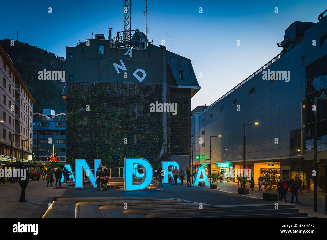 People taking pictures of iconic neon letters forming sign Andorra at ...