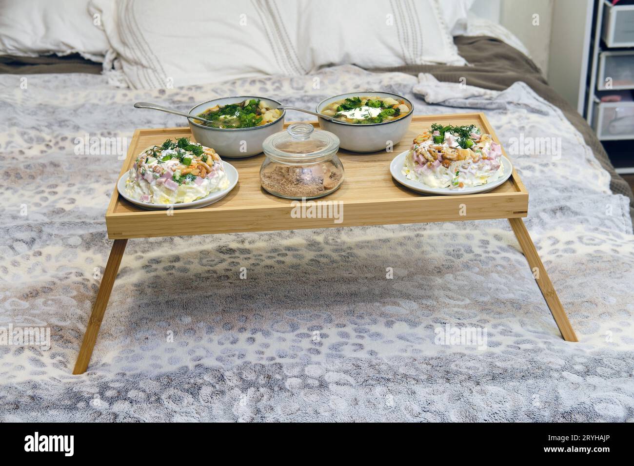 A tray of food on a bed in a hotel room. Selective focus Stock Photo ...