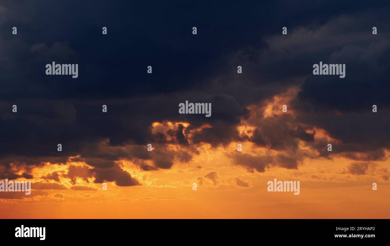 The warm glow of the down sun on a dramatic cloudy sky is a beautiful ...