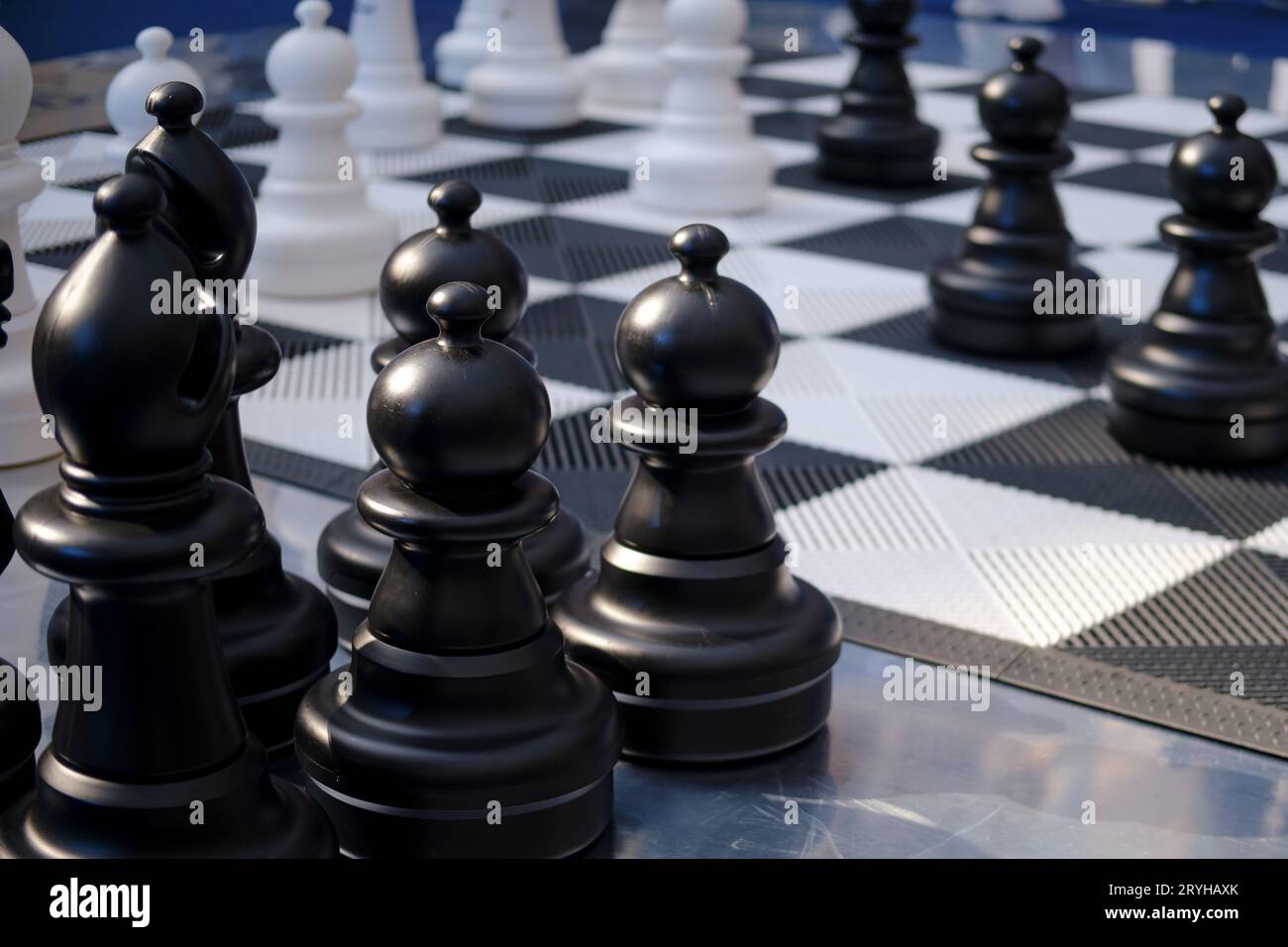 Chess large pieces on a chessboard. Big black and white figures on a ...