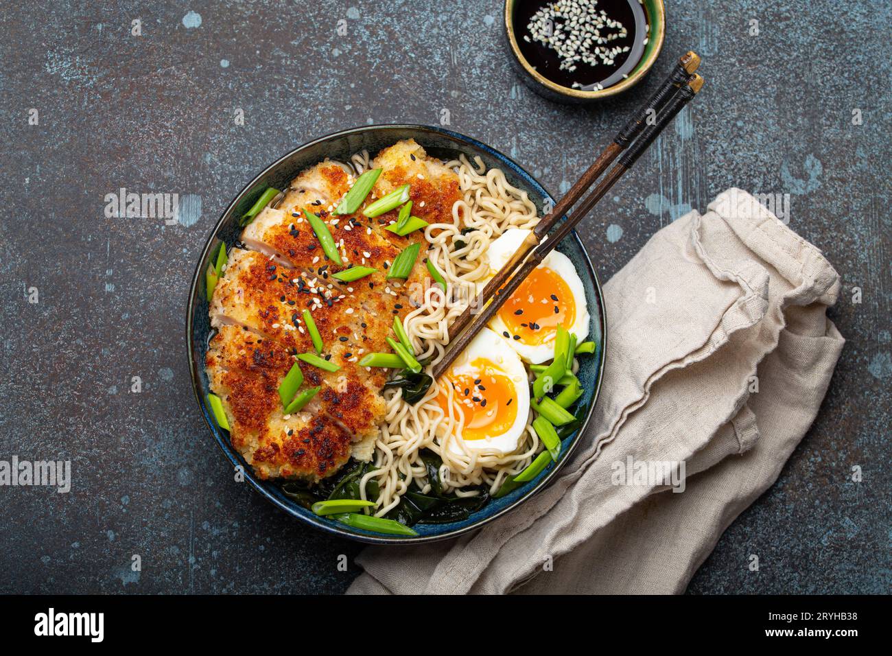 Asian noodles ramen soup with deep fried panko chicken fillet and ...