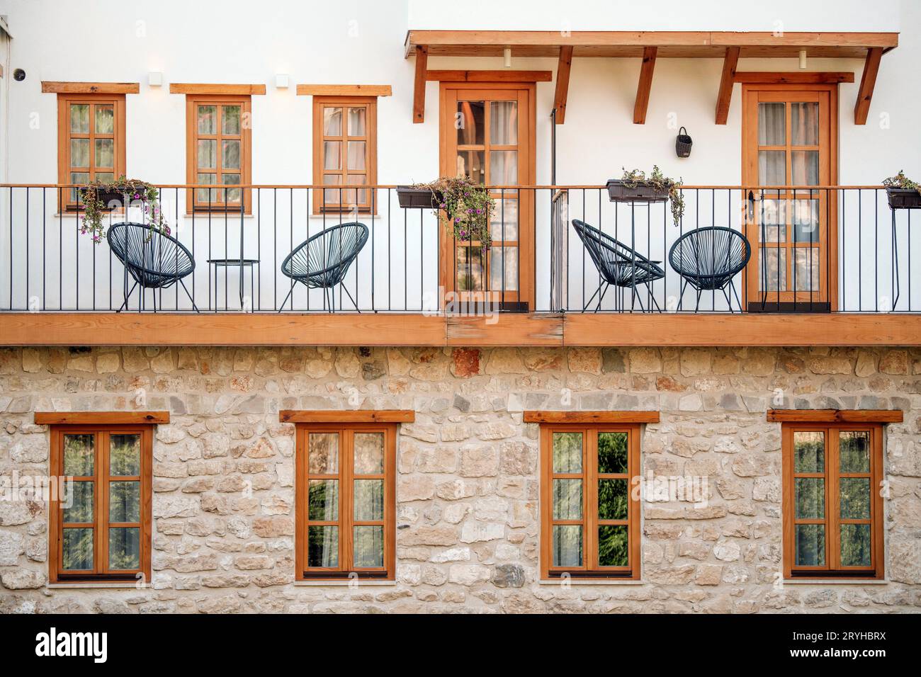 Several balconies and windows in a row on the facade of an urban ...