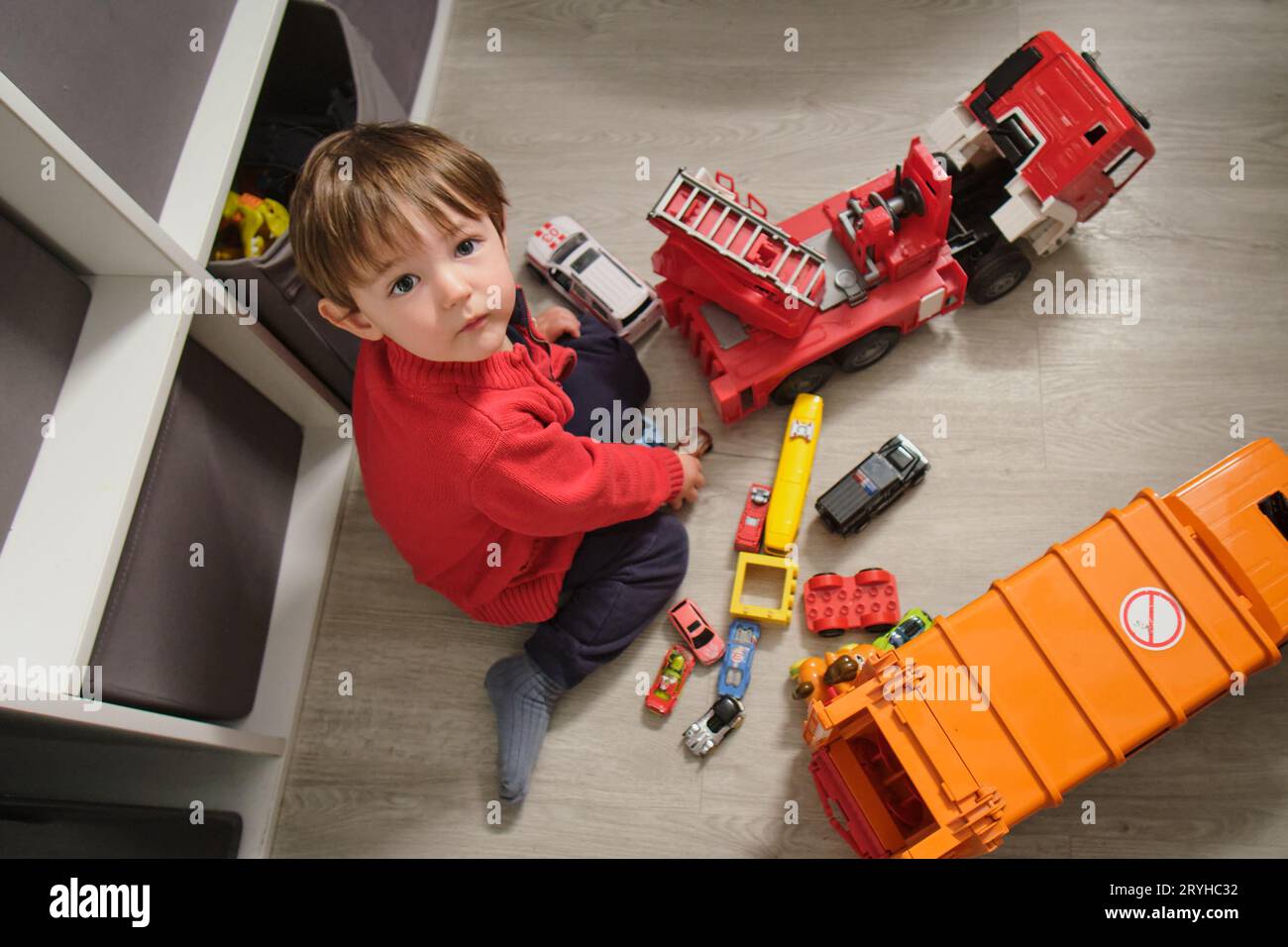 The playful child enjoys pushing his toy car around the room Stock ...