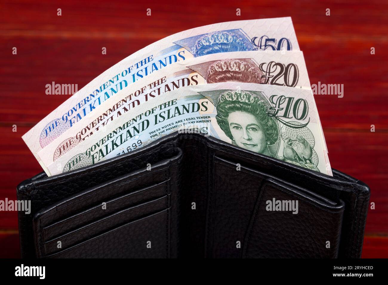Falkland Islands pounds in the black wallet Stock Photo - Alamy