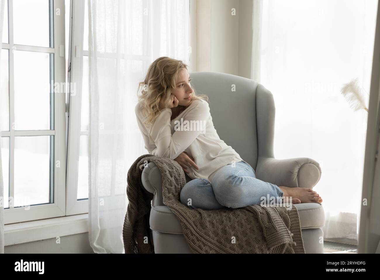 Young pensive lady relaxing alone at home Stock Photo - Alamy