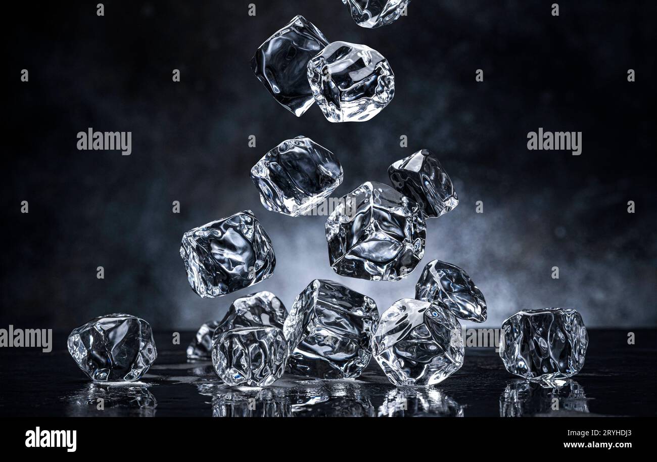 Falling ice cubes on black background Stock Photo - Alamy