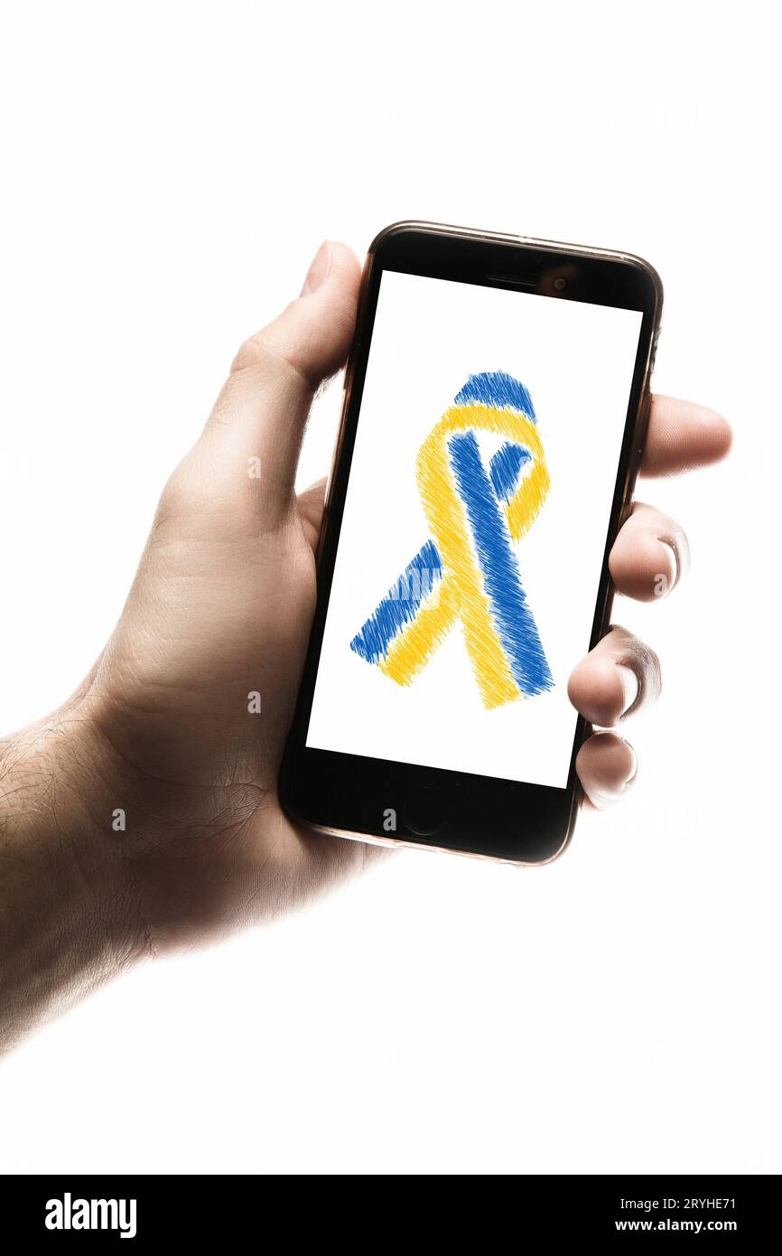 smartphone in hands on screen yellow blue ribbon Stock Photo - Alamy