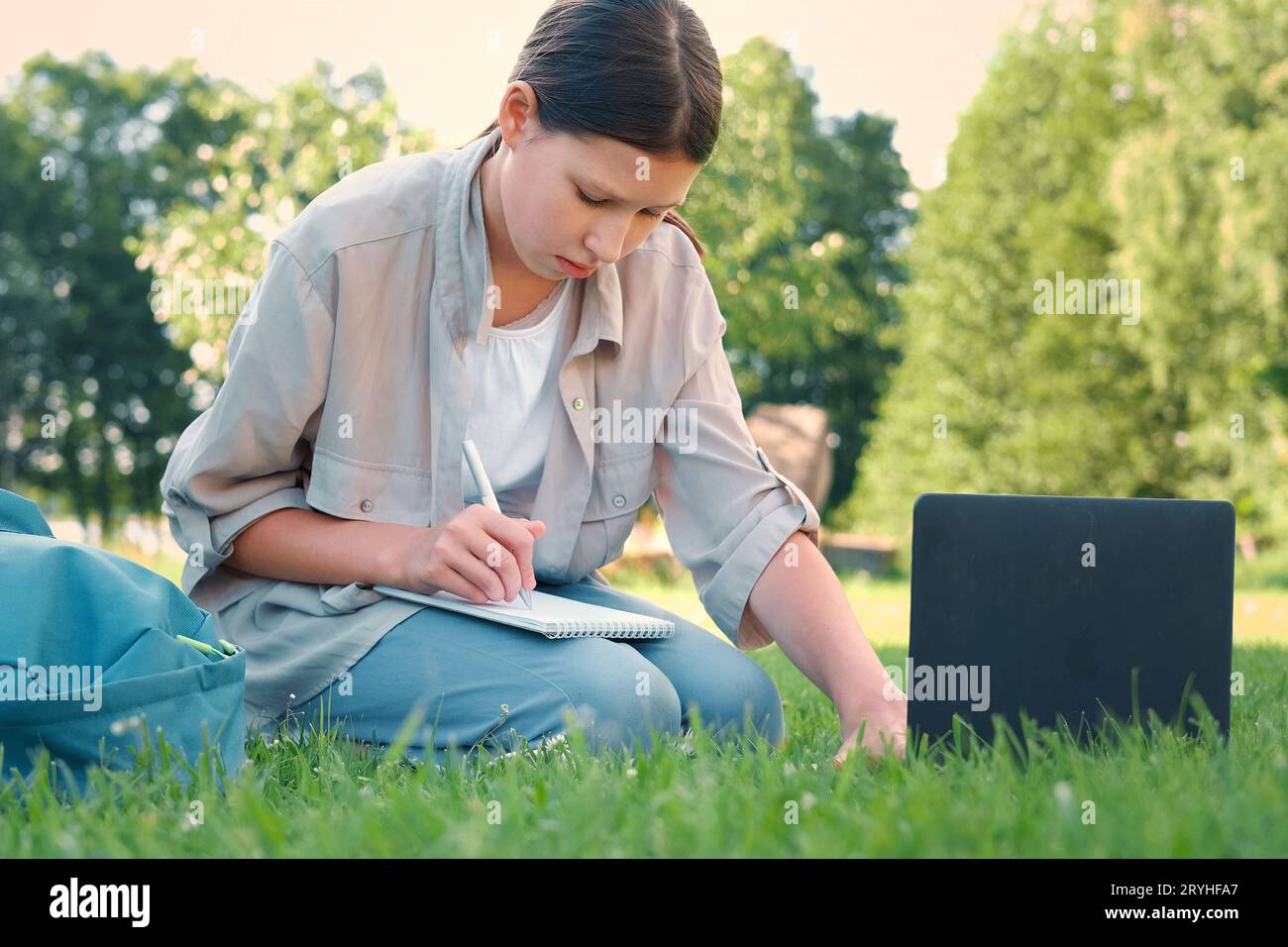 Teenage schoolgirl studying reading her books, tablet and notebook ...