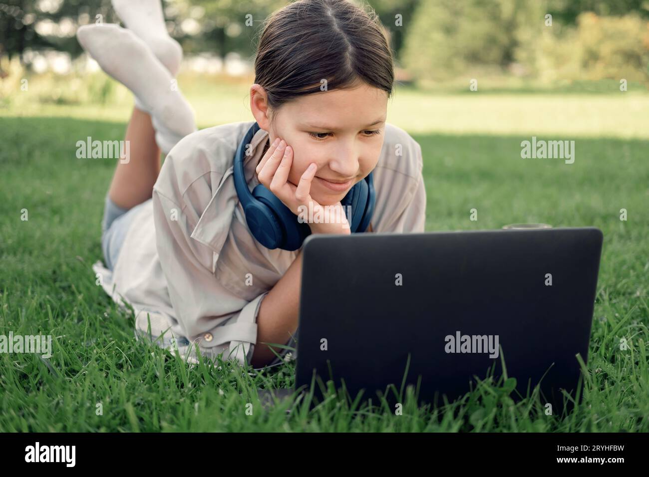 Teenage schoolgirl studying reading her books, tablet and notebook ...