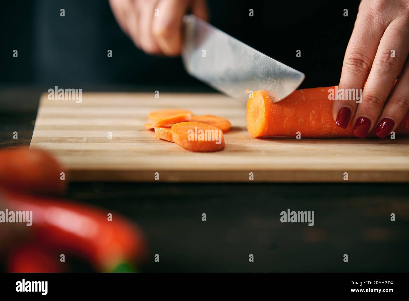 Woman chopping carrots on hi-res stock photography and images - Alamy