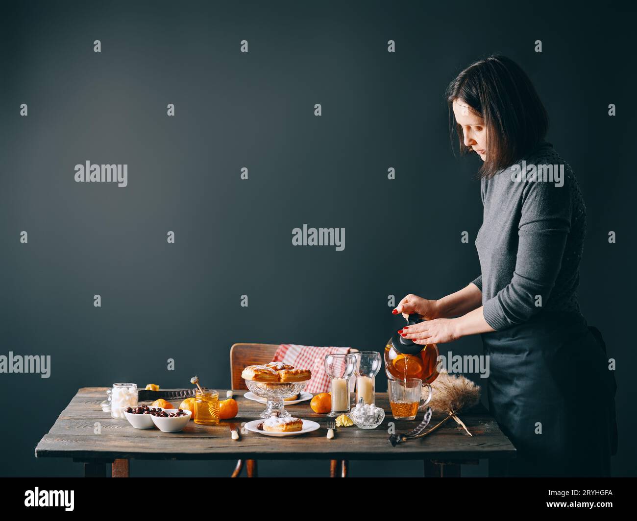 Female serving food and pouring hot aromatic tea to the cup Stock Photo ...