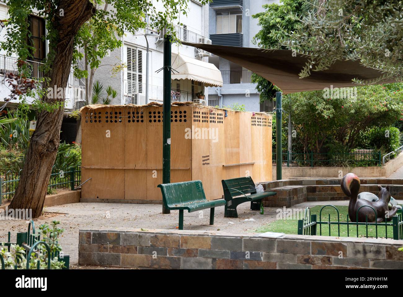 Wooden sukkah in a yard of a residential building in Israeli town ...