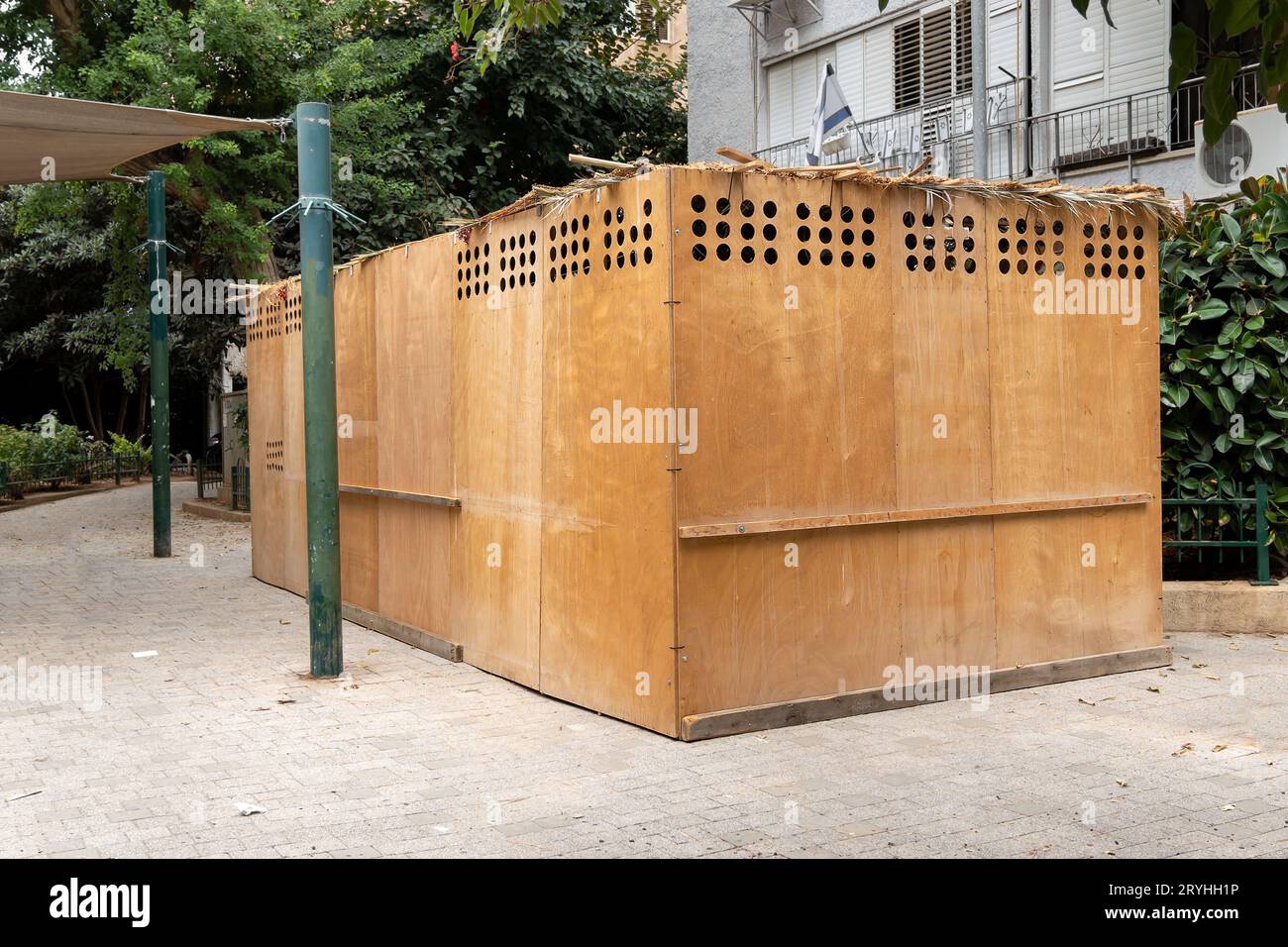 Wooden sukkah in a yard of a residential building in Israeli town ...
