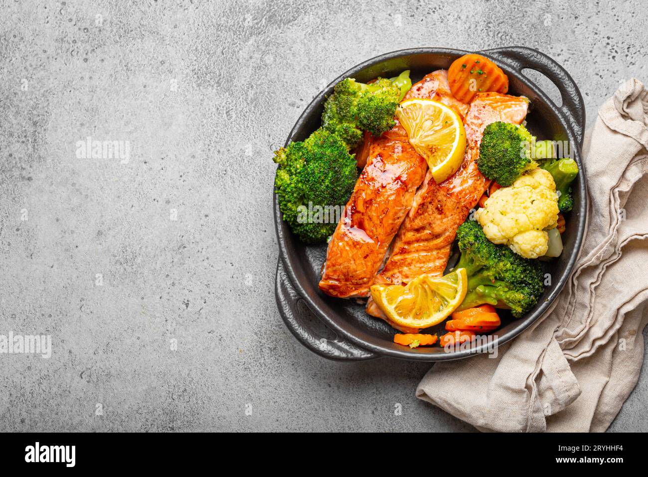 Healthy baked fish salmon steaks, broccoli, cauliflower, carrot in ...