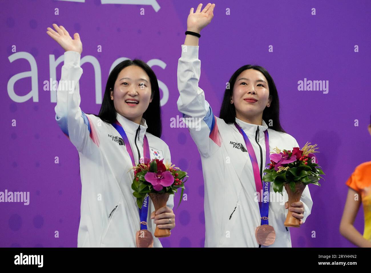 Bronze medalist South Korea's Hareum Park and Suji Kim waves during ...