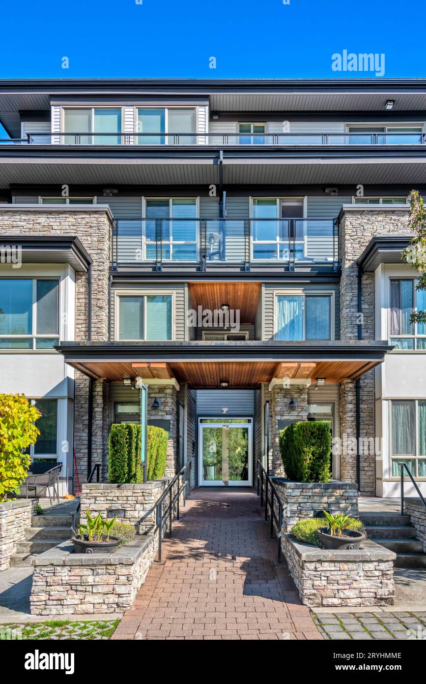 Entrance of residential apartment building with paved pathway in front ...