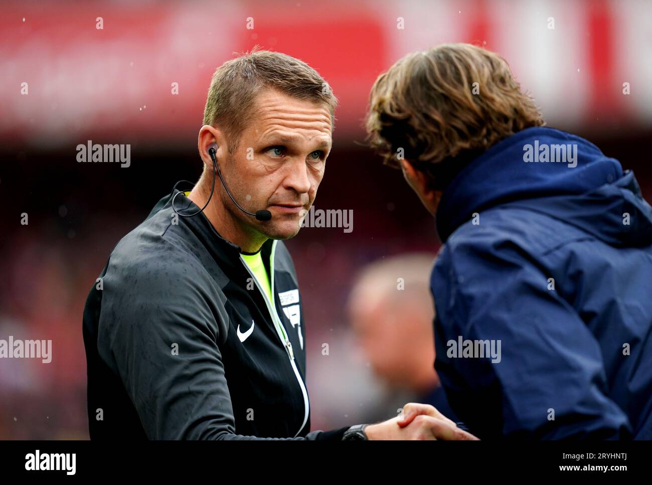 Brentford manager Thomas Frank (right) shakes hands with fourth ...