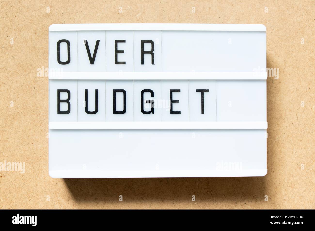 Lightbox with word over budget on wood background Stock Photo - Alamy