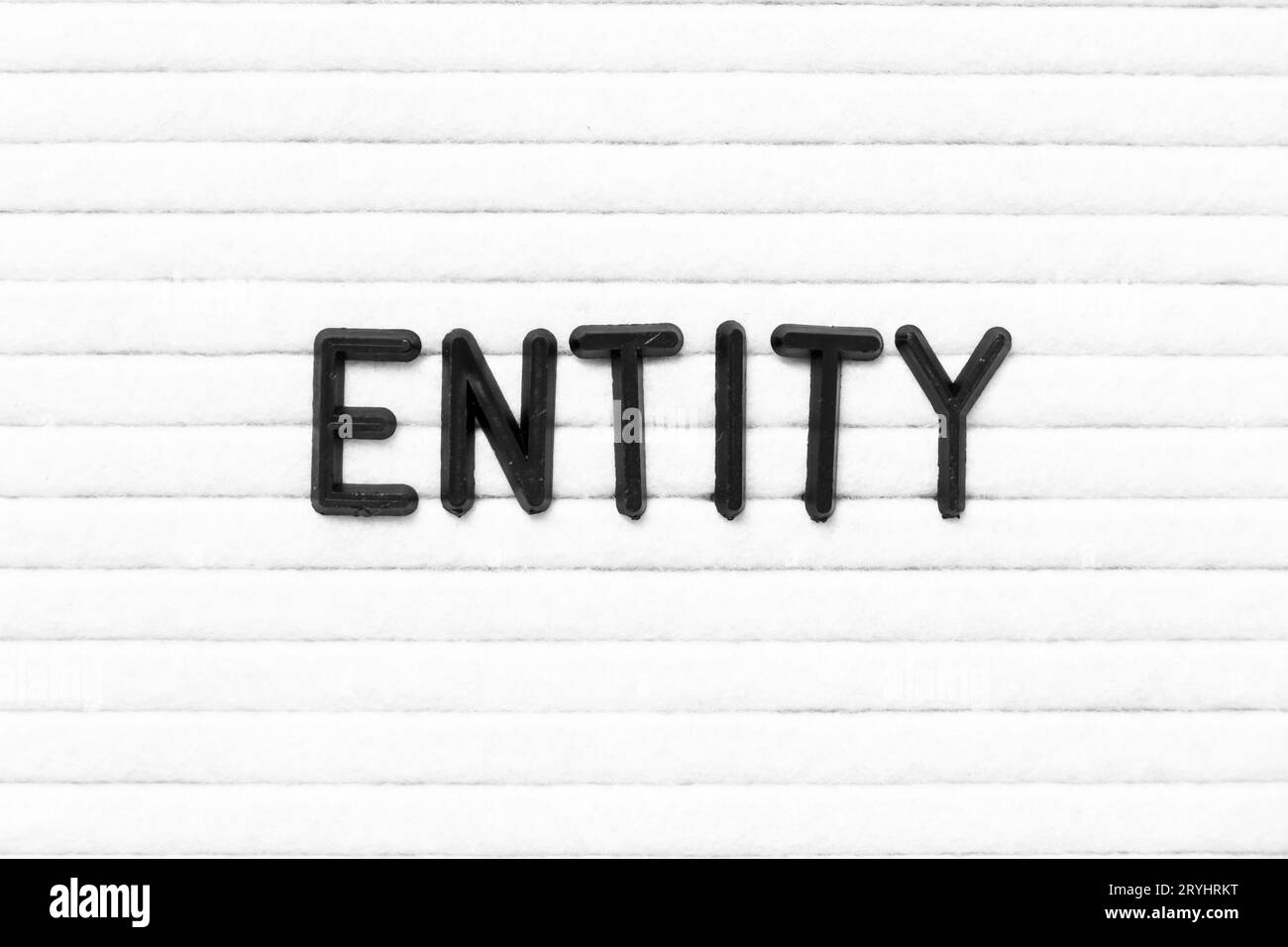 Black color letter in word entity on white felt board background Stock ...