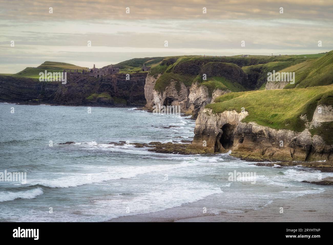 Dunluce Castle on the edge of cliff and limestone rock formations ...