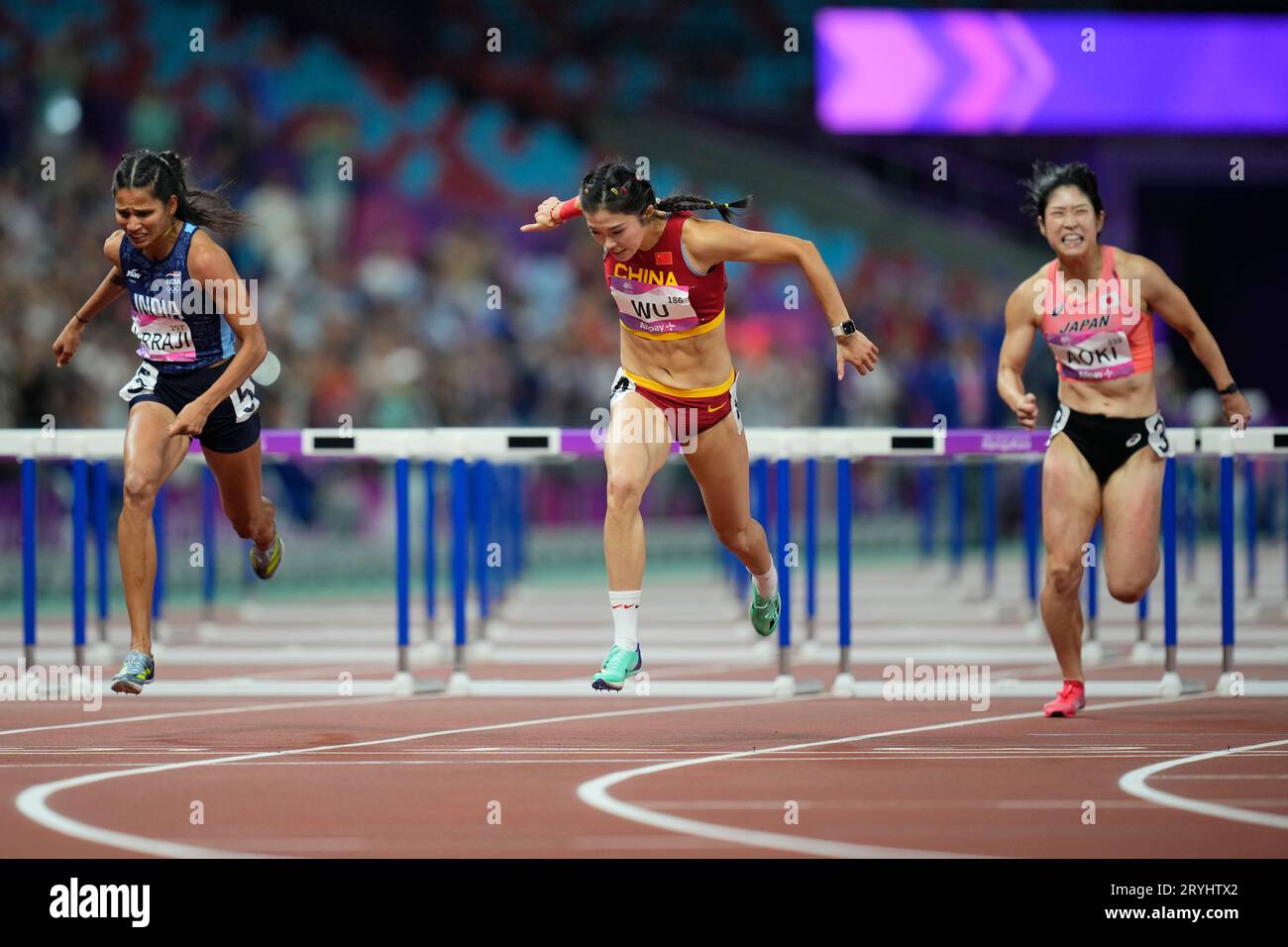 China's Wu Yanni, center, crosses the finish line during the women's ...