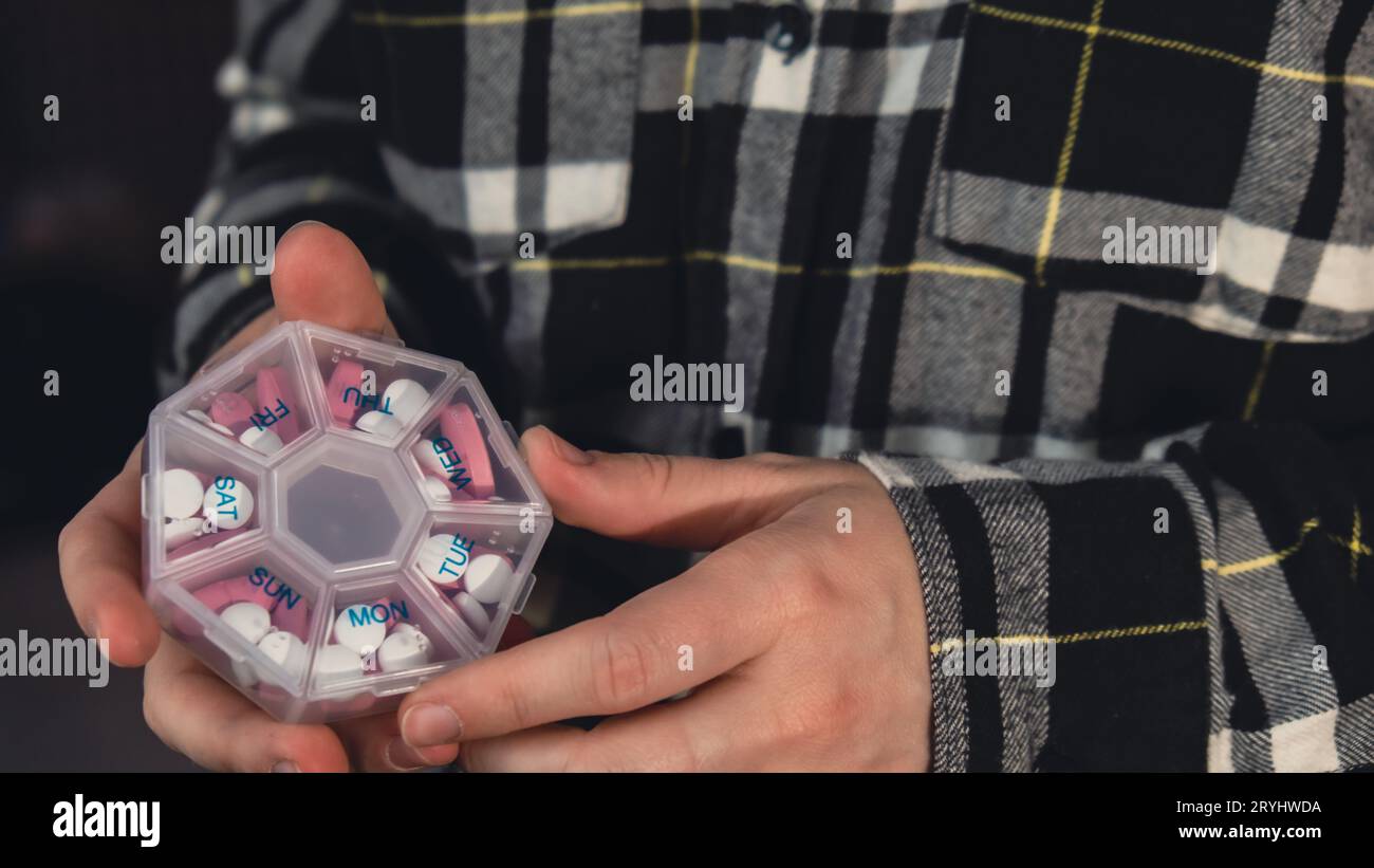 Female hands sorting pills Organizer weekly shots Closeup of medical ...