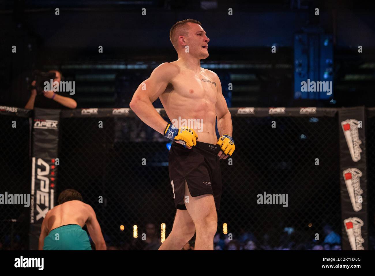 Rory Evans (black shorts) submits Adam Wilson (green shorts) during the Cage Warriors 160 MMA ...