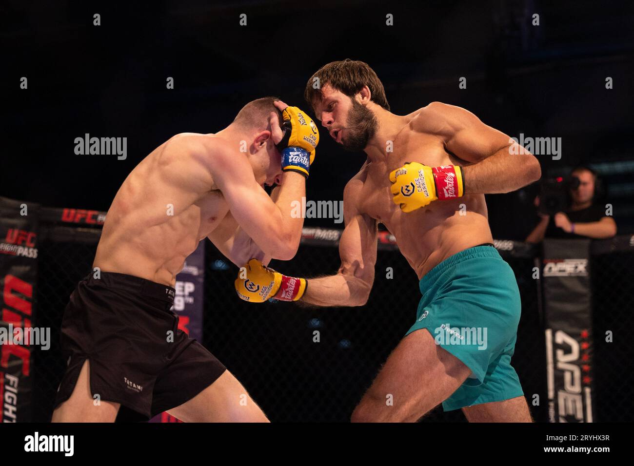 Rory Evans (black shorts) is punched by Adam Wilson (green shorts) during the Cage Warriors 160 ...