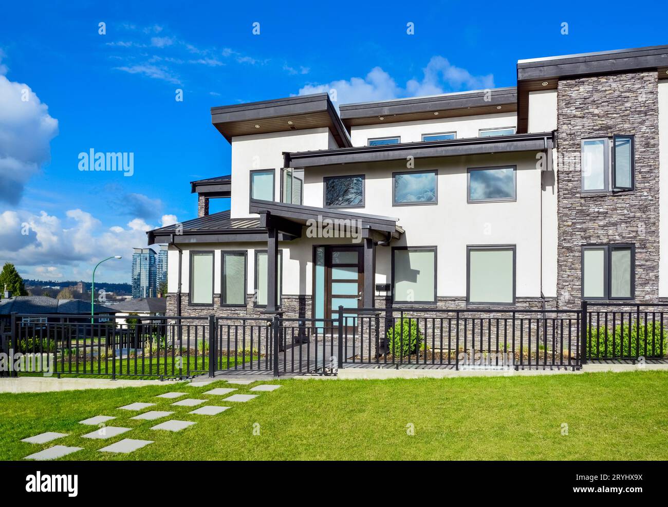 New residential house with concrete tile pathway over the front yard ...
