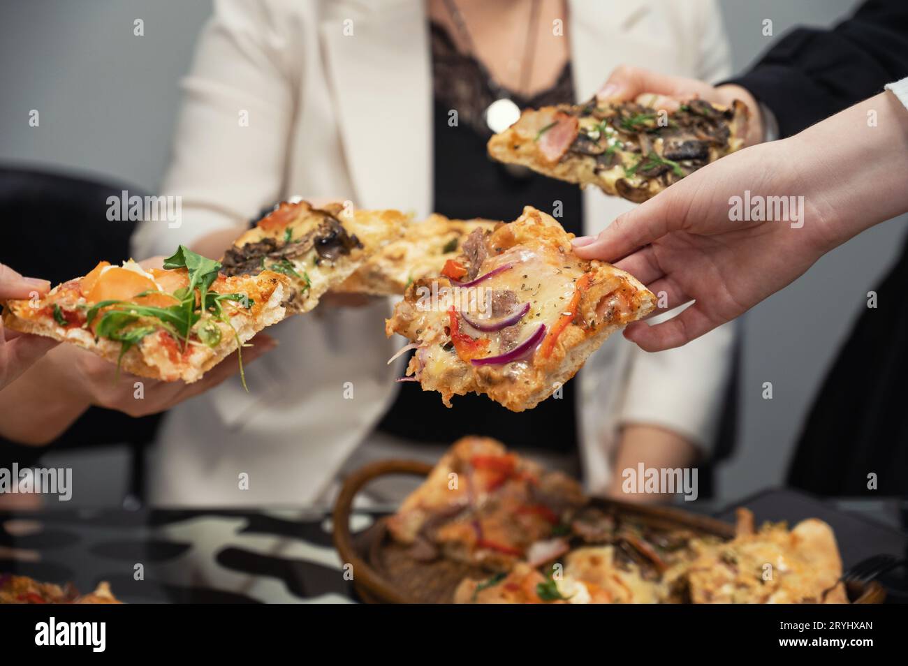 Team people eating pizza Stock Photo - Alamy