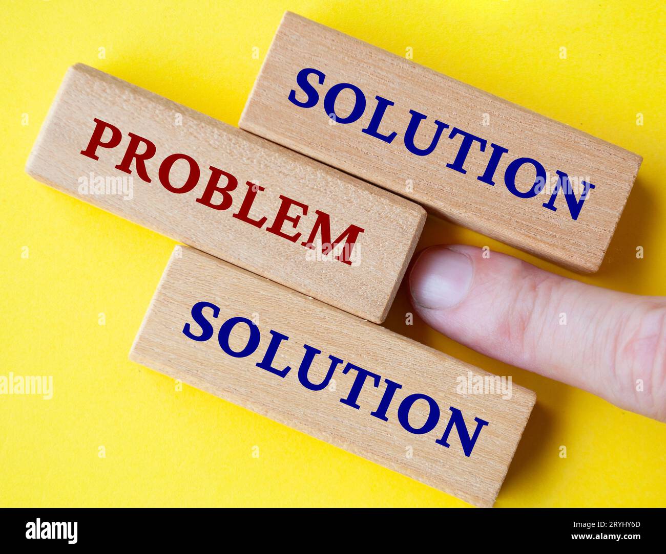 Hand pushing wooden block with text, problem. Solutions to problems ...
