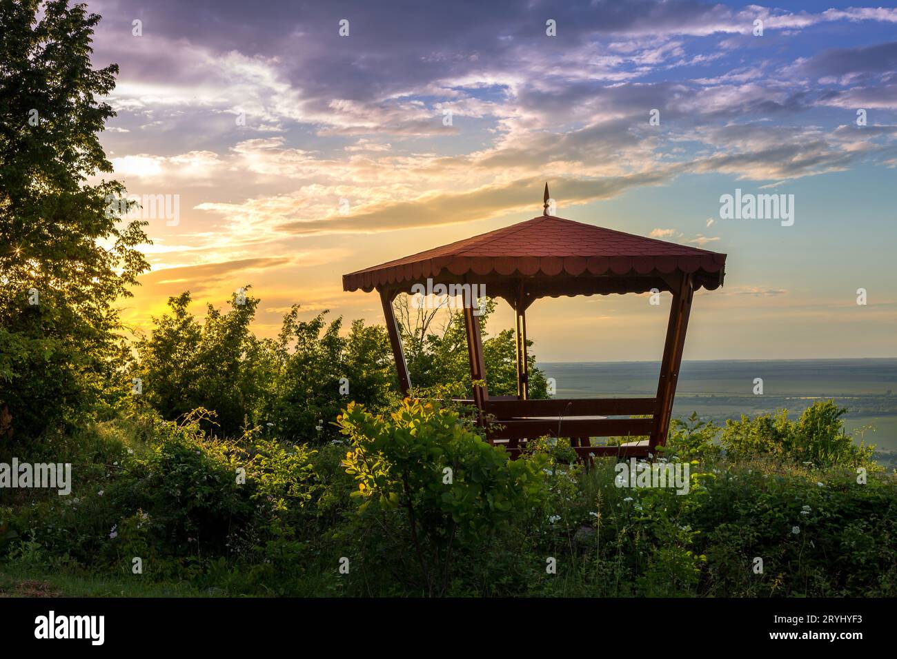 Wooden gazebo over summer sunset landscape Stock Photo - Alamy