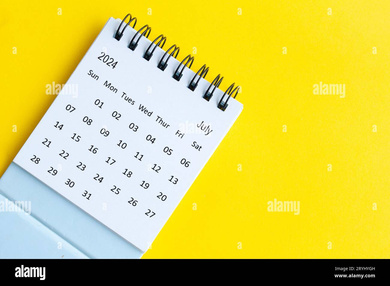 July 2024 table calendar on yellow cover background with customizable ...