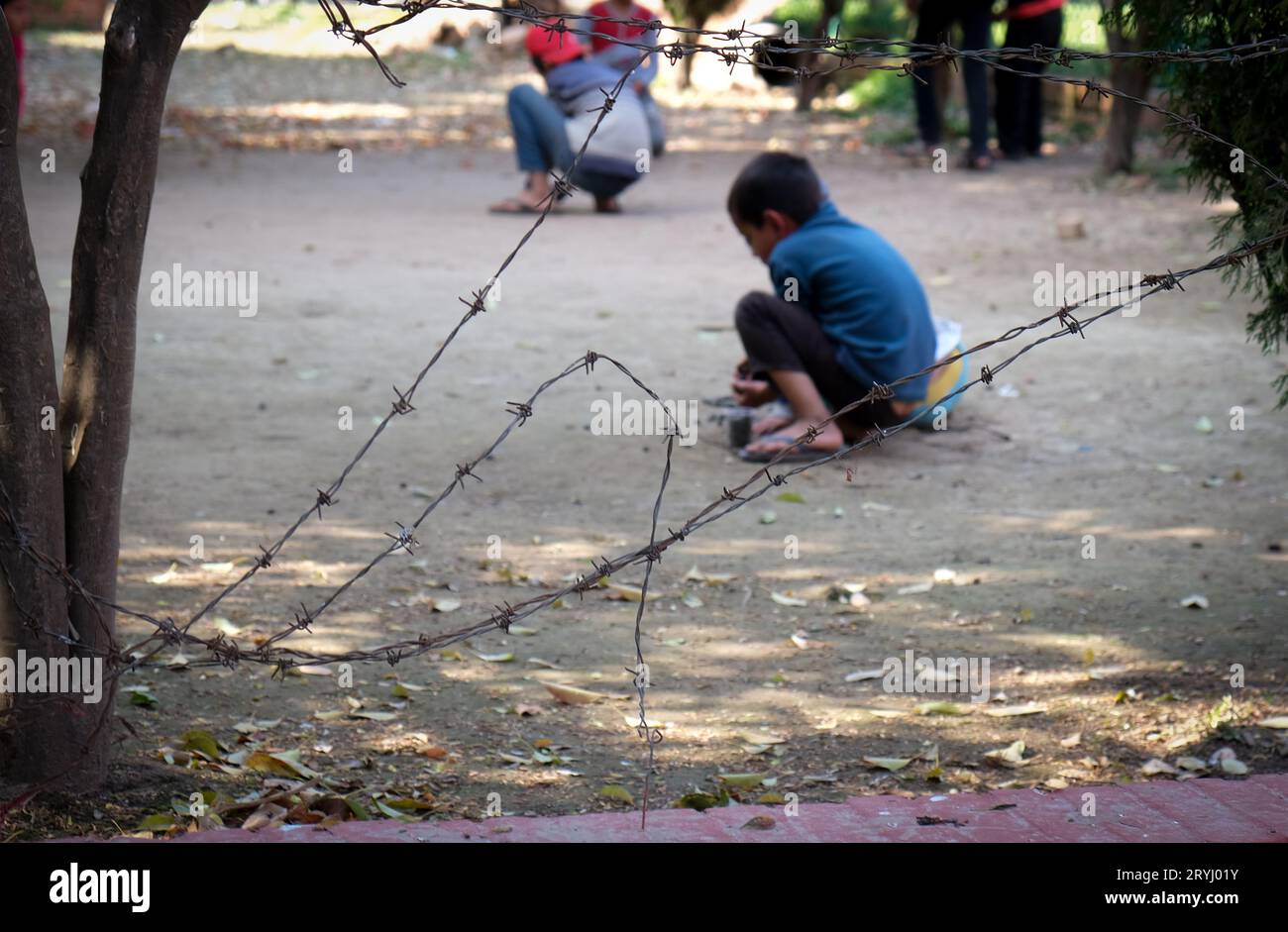 Children playing behind a fence hi-res stock photography and images - Alamy