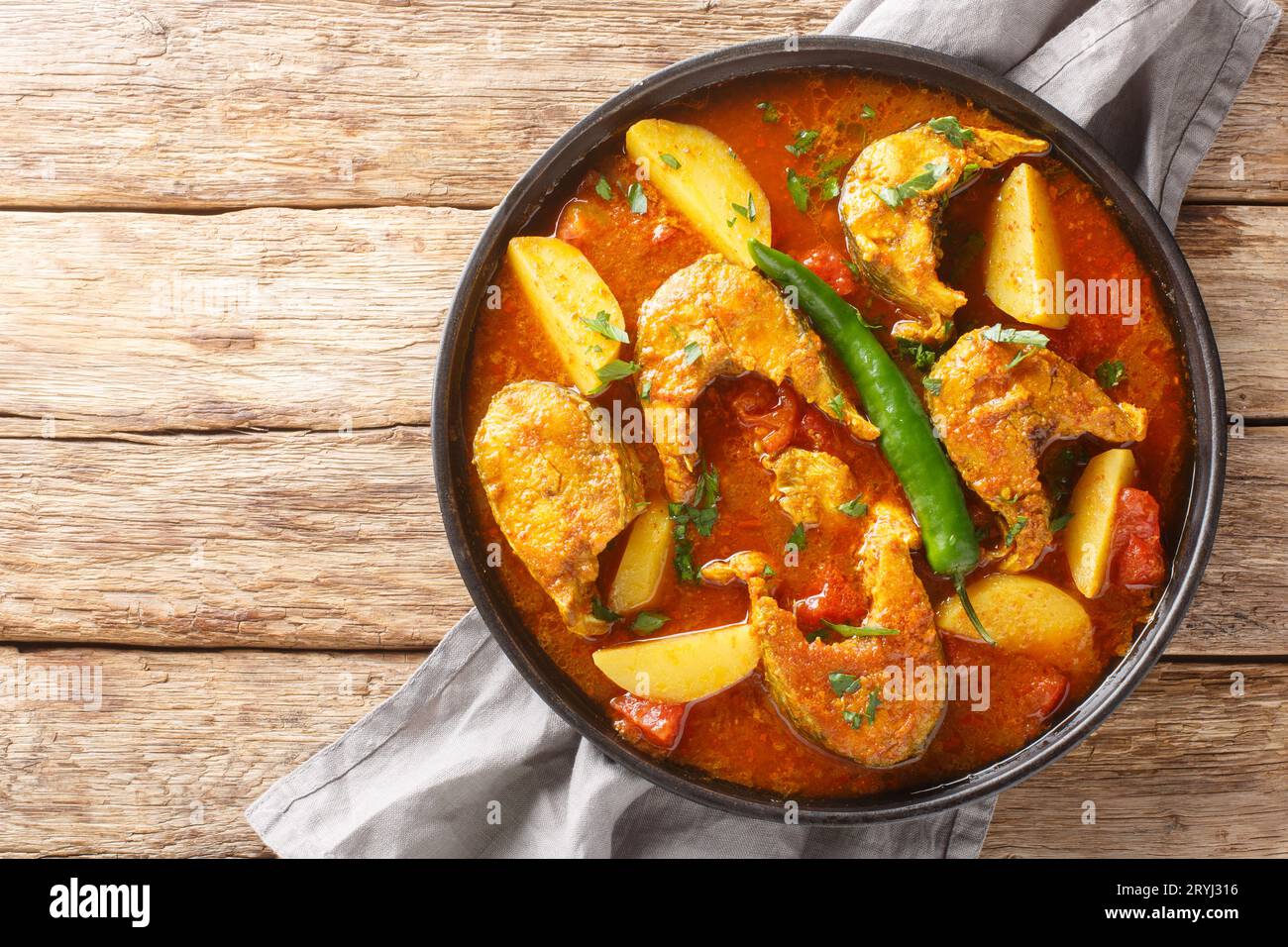 Tasty Asian fish curry seasoned with turmeric, garlic, onions, and ...