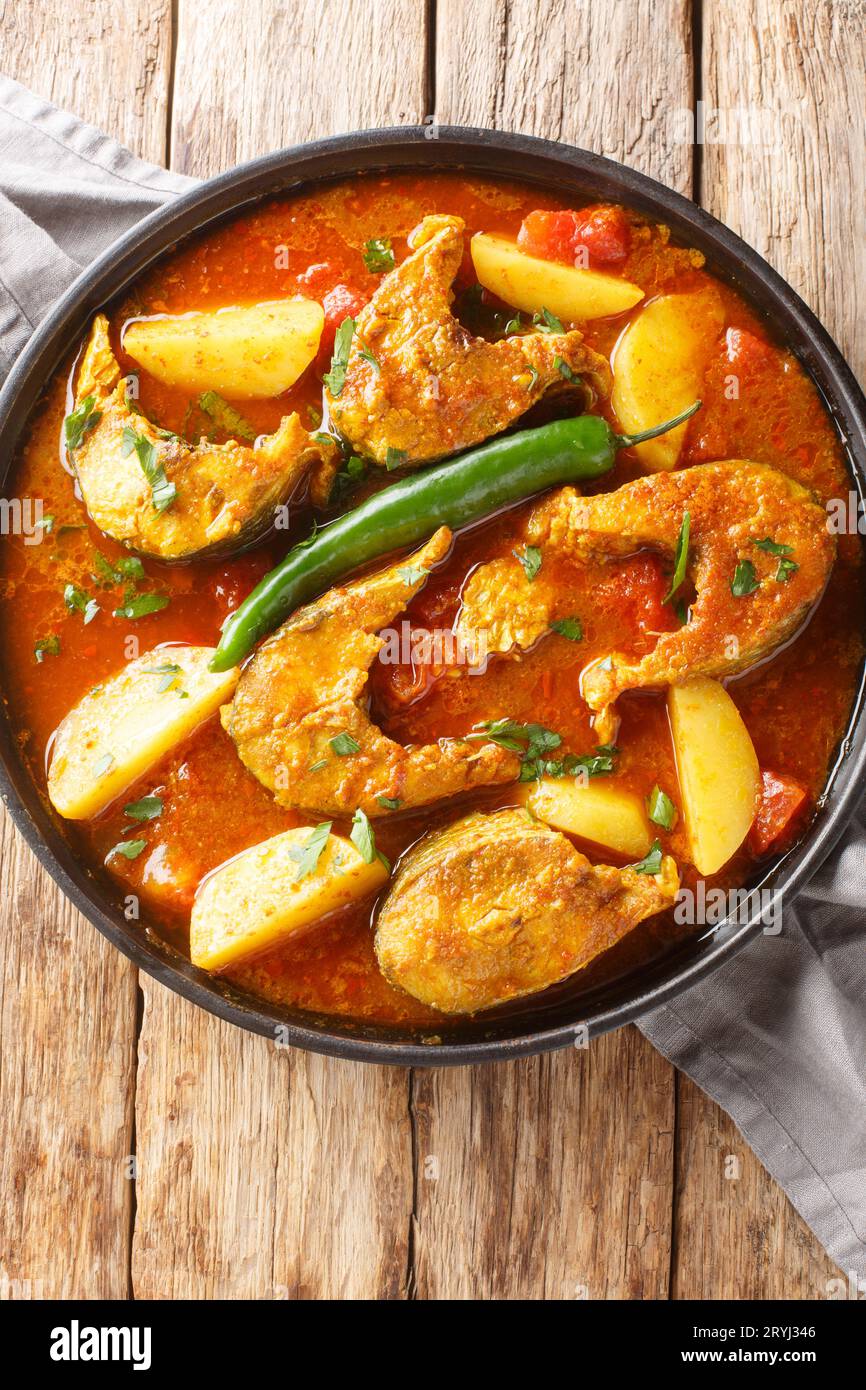 Indian cuisine Bengali Fish Curry Macher Jhol closeup on the plate on ...