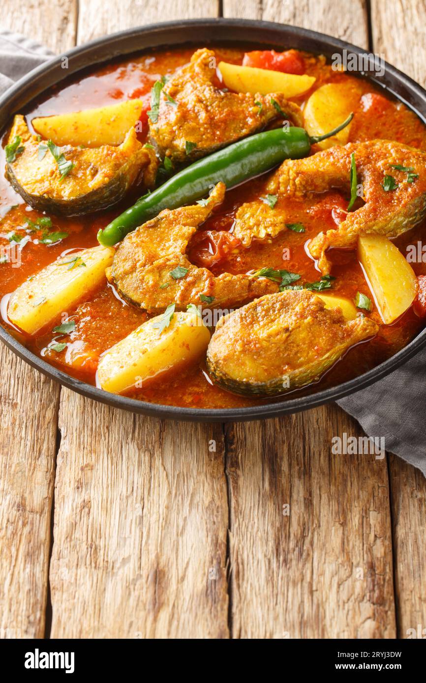 Indian cuisine Bengali Fish Curry Macher Jhol closeup on the plate on ...