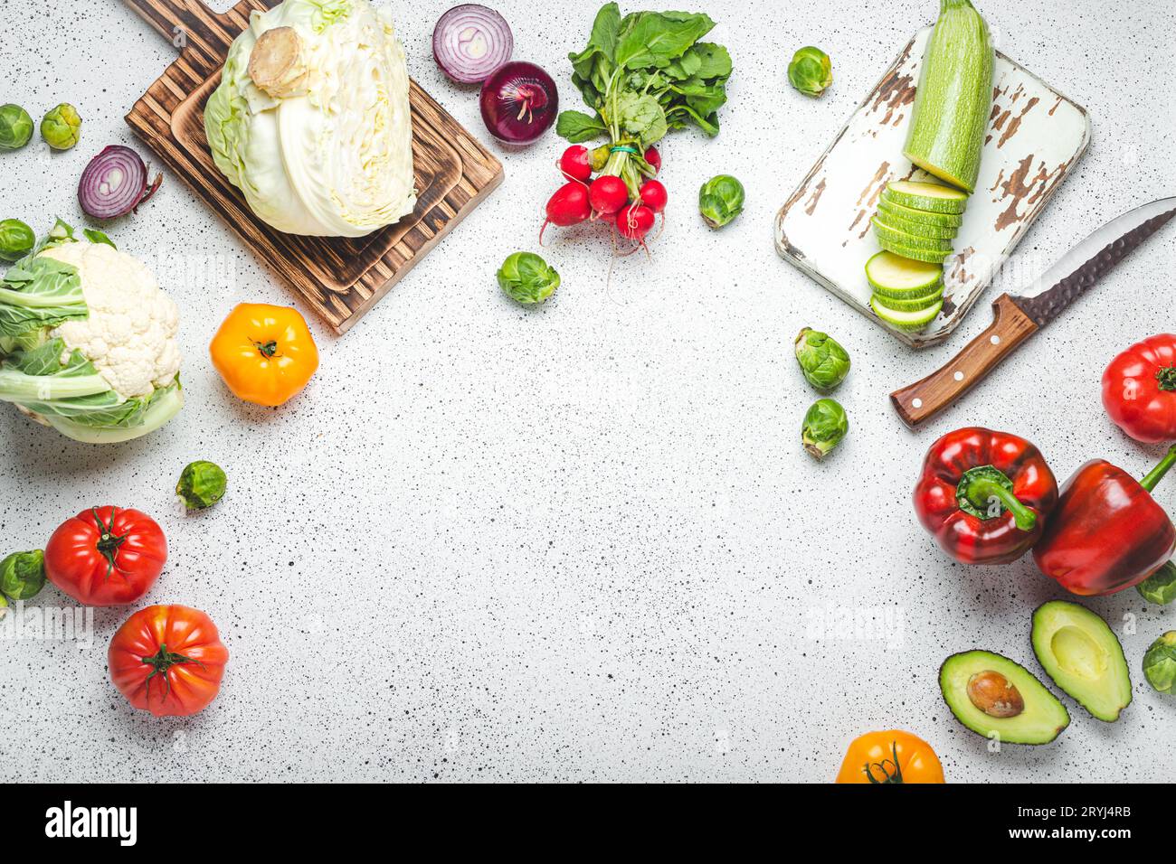 Fresh various vegetables, wooden cutting boards and knife on white ...