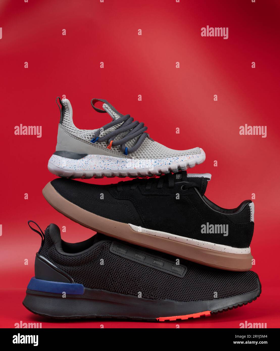 Sport shoes stack isolated on red studio background side view Stock ...