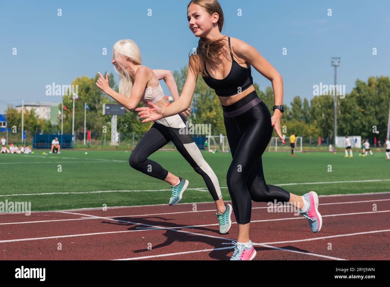 Two athlete woman runnner are training Stock Photo - Alamy