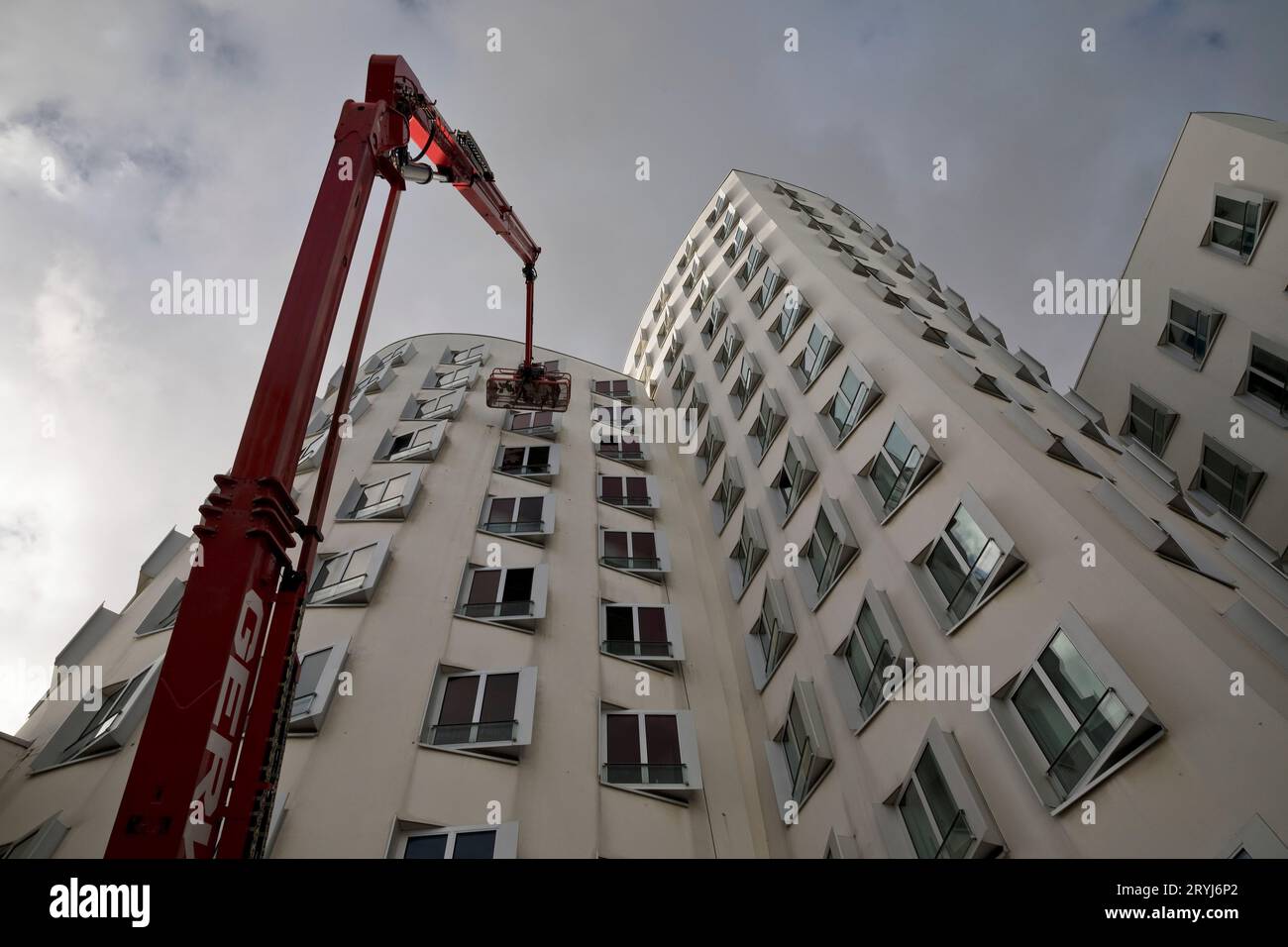 Building cleaners on a work platform with an extended crane at Gehry ...