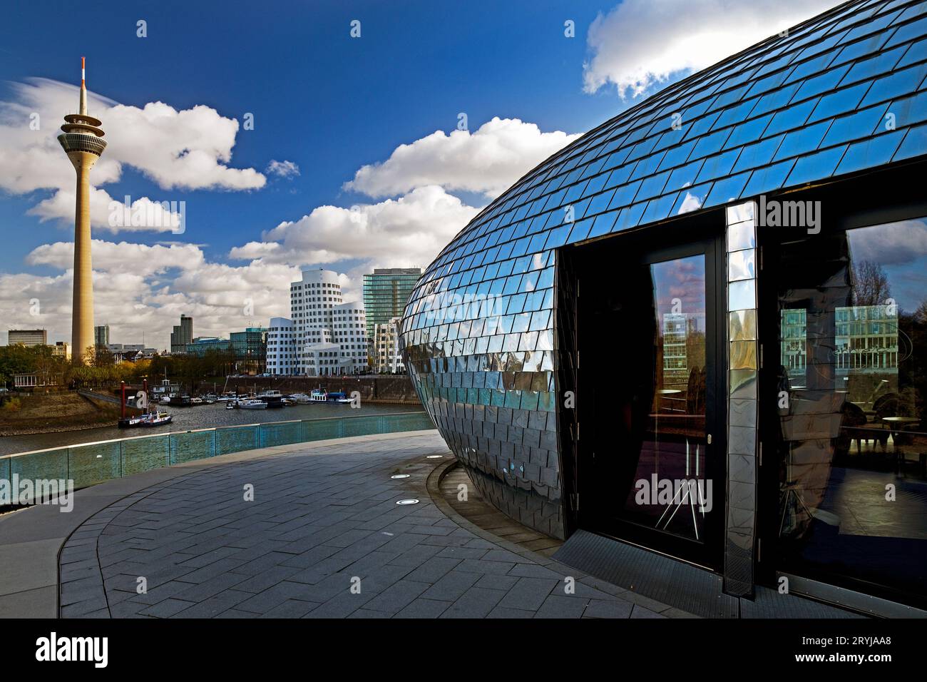 Restaurant terrace with the Rhine Tower and the Gehry buildings ...