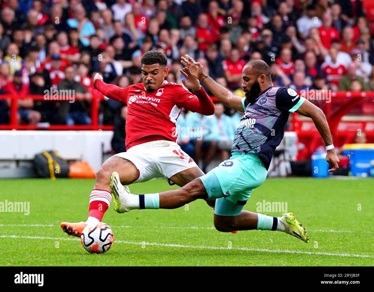 Nottingham Forest's Morgan Gibbs-White (left) tackles Brentford's Bryan ...