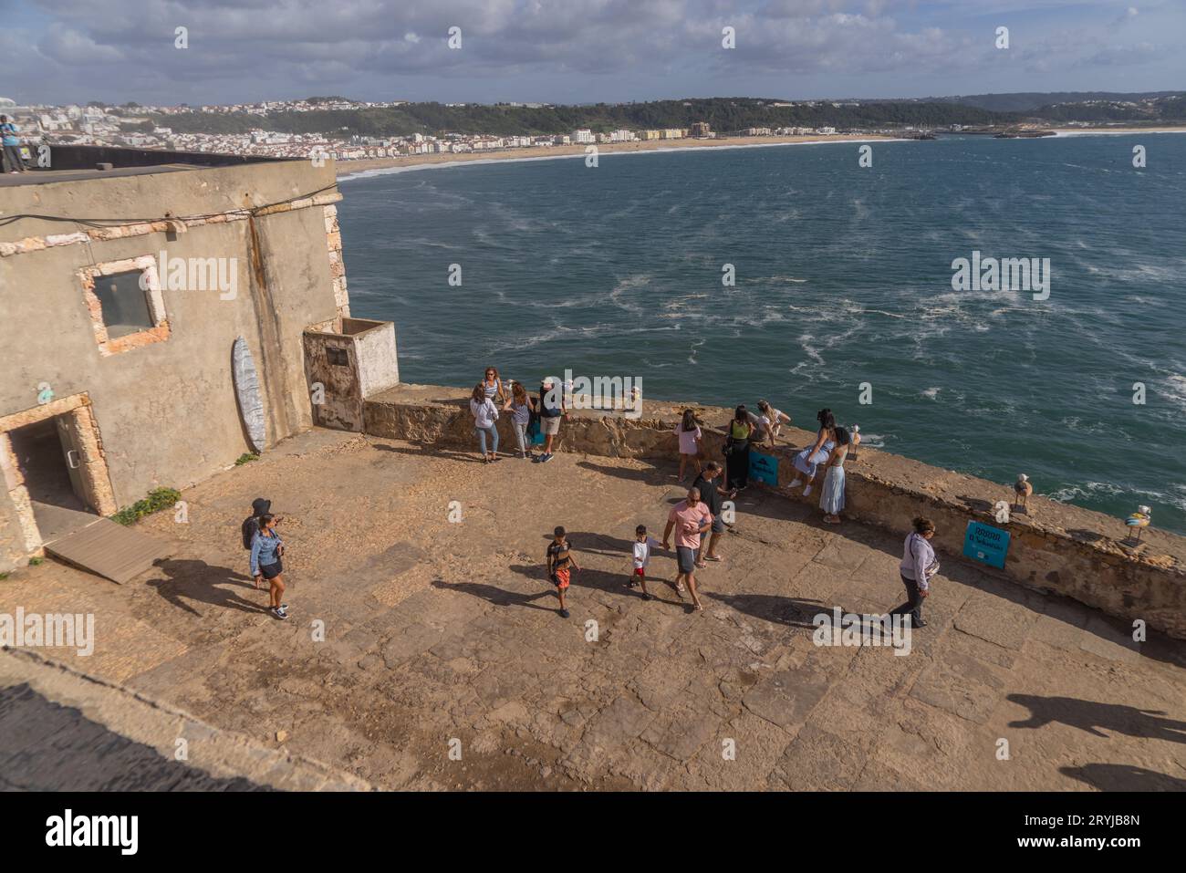 View of windy surfing north beach, fort and lighthouse in Nazare ...