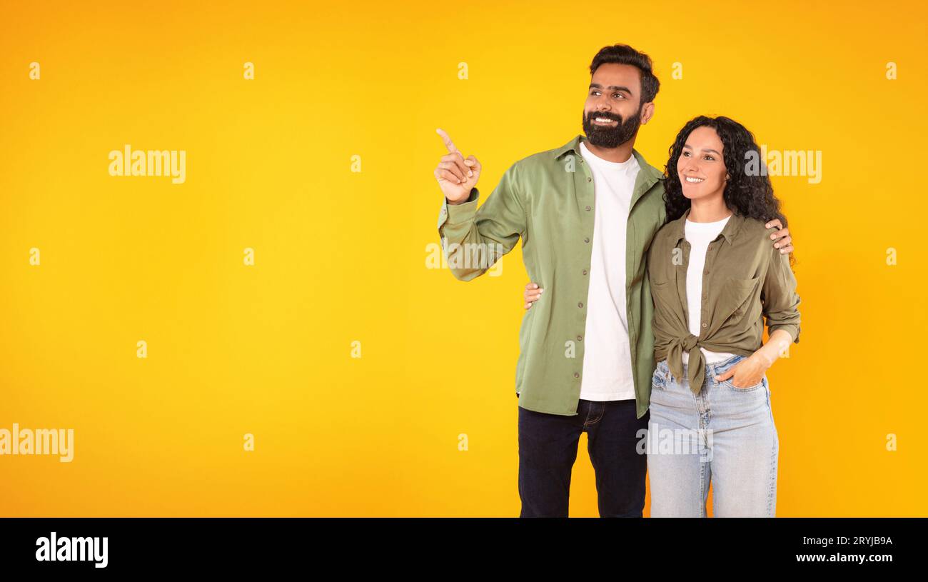 Arab Man Hugging Lady Pointing Showing Copy Space, Yellow Background ...