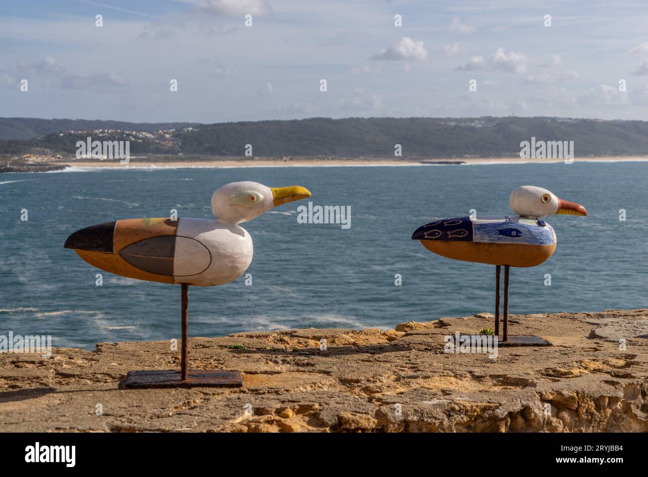 View of windy surfing north beach, fort and lighthouse in Nazare ...