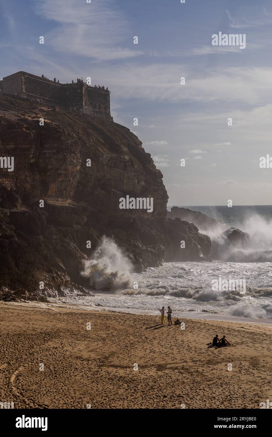 View of windy surfing north beach, fort and lighthouse in Nazare ...