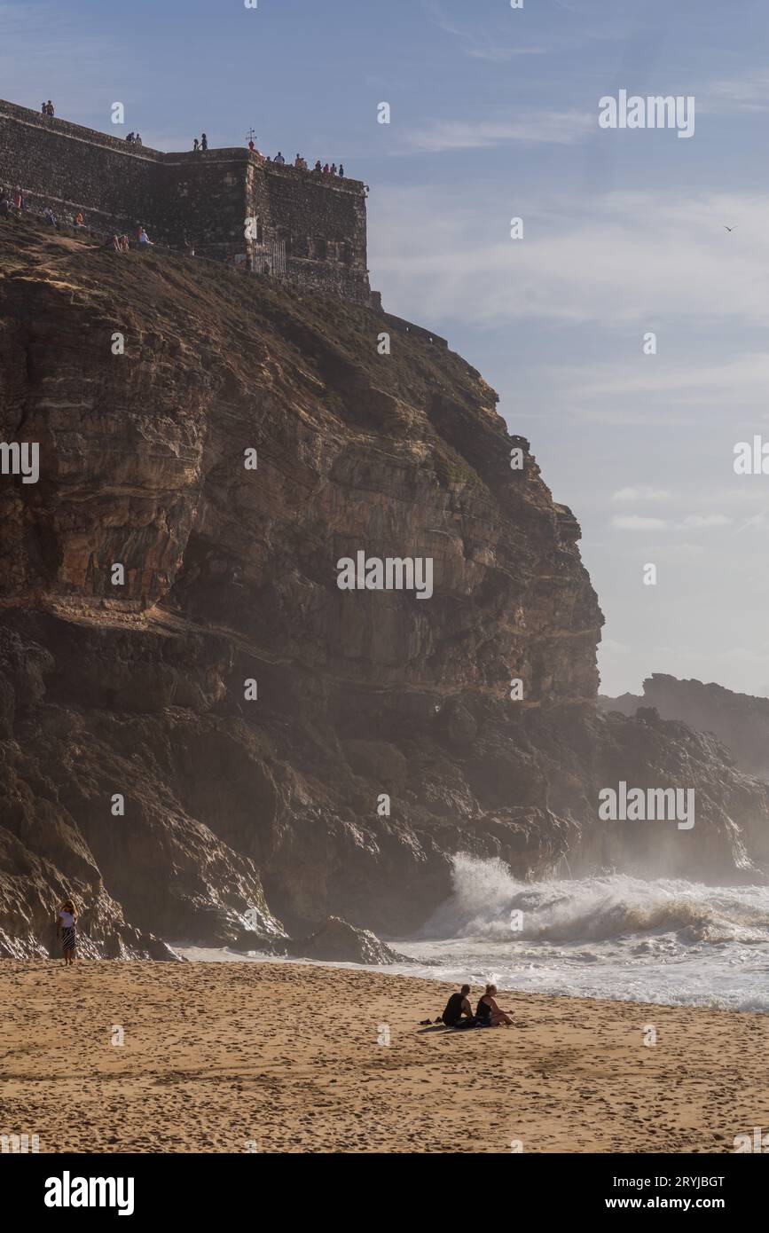 View of windy surfing north beach, fort and lighthouse in Nazare ...